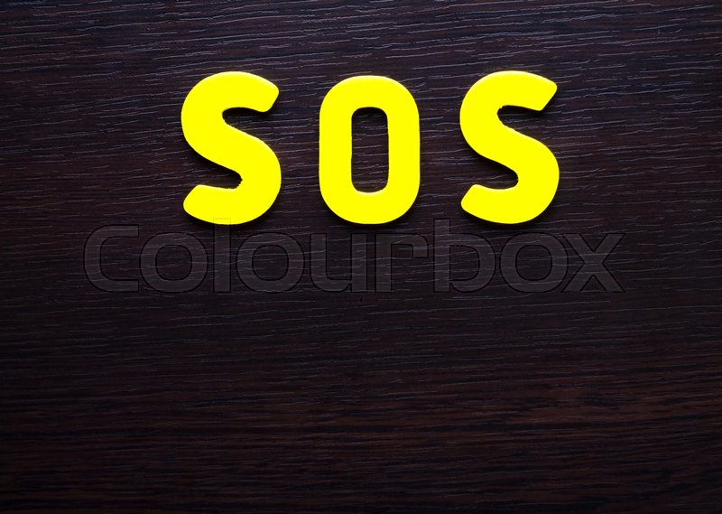SOS yellow letters on dark brown ... | Stock image | Colourbox