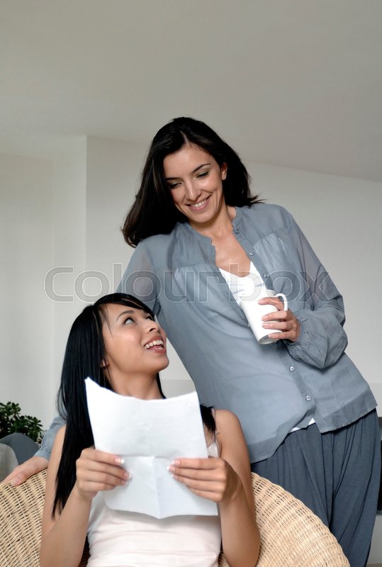 Two women reading a letter | Stock image | Colourbox