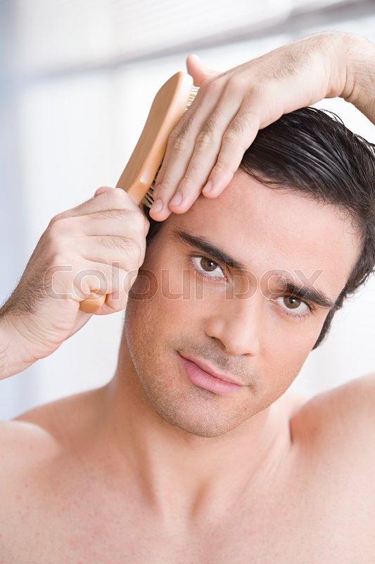 Man combing his hair | Stock image | Colourbox