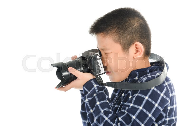 Asian boy holding camera on white ... | Stock image | Colourbox