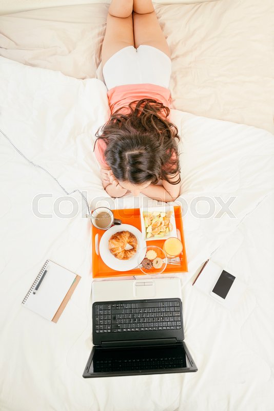 Woman watching the laptop computer and ... | Stock image | Colourbox