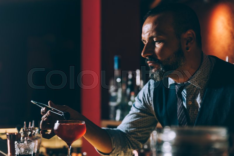 Expert barman is making cocktail at ... | Stock image | Colourbox