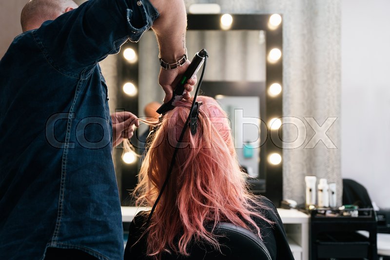 Beautiful woman getting haircut by ... | Stock image | Colourbox