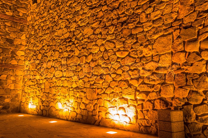 Illuminated stone wall at night in ... | Stock image | Colourbox