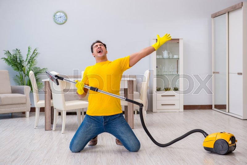 Young man doing chores at home | Stock image | Colourbox