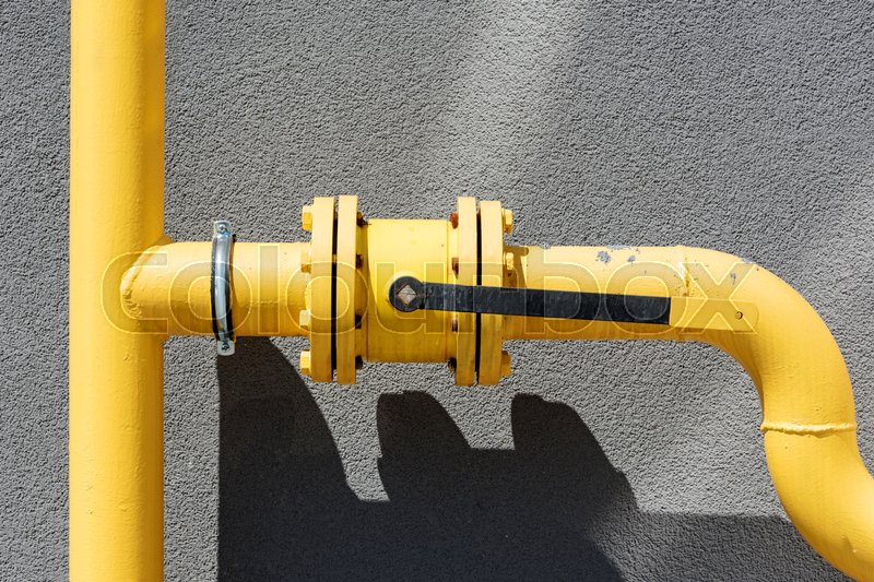 Yellow metal gas pipeline with valve on ... | Stock image | Colourbox