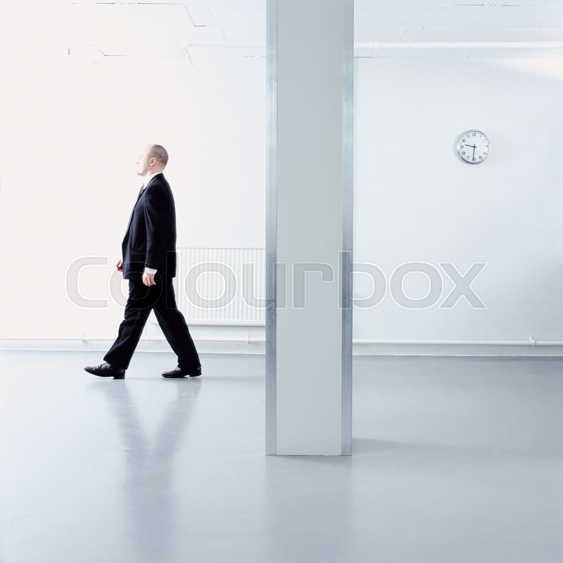 A man walking through an office. | Stock image | Colourbox