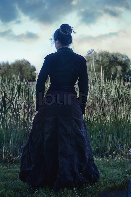 A woman in antique clothes near a swamp | Stock image | Colourbox