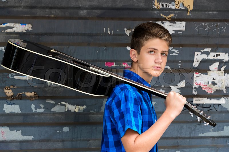 Young sad guy with an acoustic guitar | Stock image | Colourbox