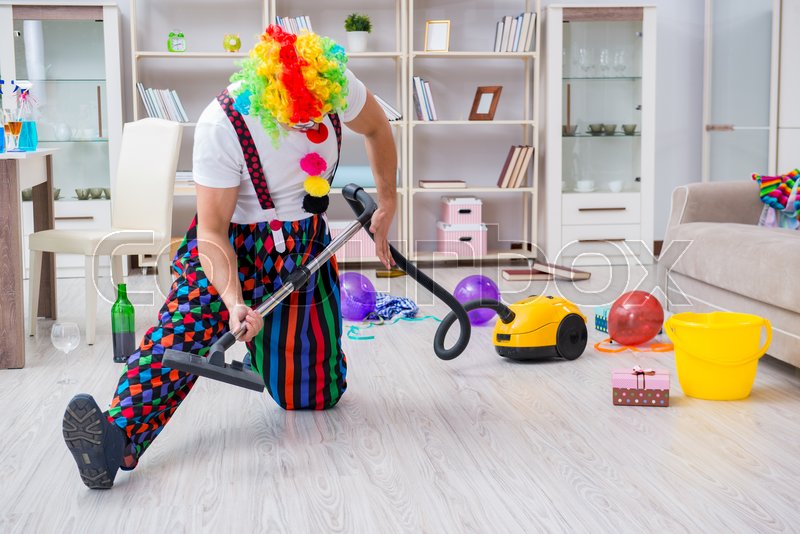 Funny clown doing cleaning at home | Stock image | Colourbox
