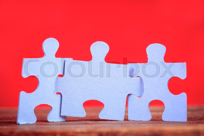 Three jigsaw puzzle pieces on a table ... | Stock image | Colourbox