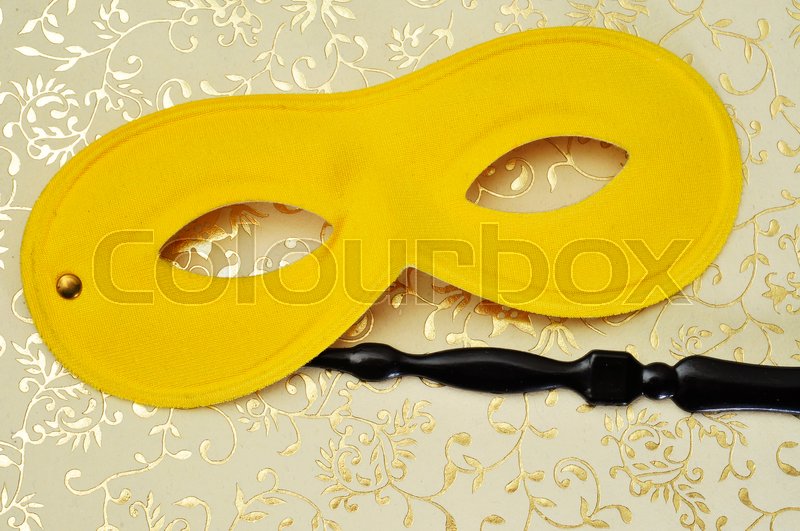 Elegant carnival mask with handle on a ... | Stock image | Colourbox