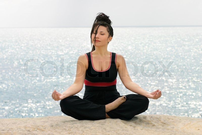 A beautiful woman in meditation by the ... | Stock image | Colourbox
