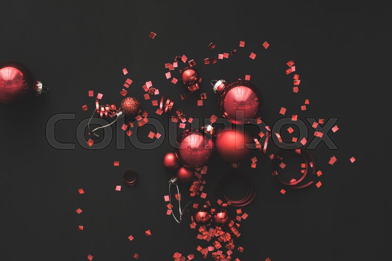 Red christmas balls and confetti on ... | Stock image | Colourbox