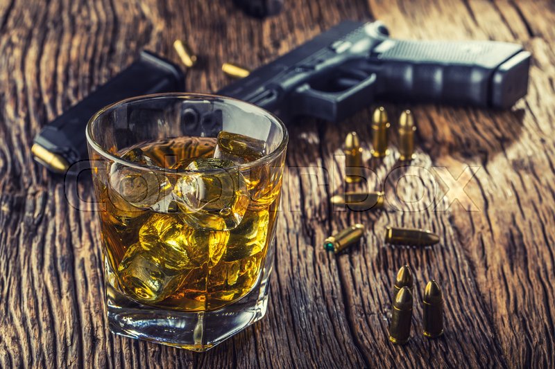 Gun and alcohol. 9mm pistol gun and cup ... | Stock image | Colourbox