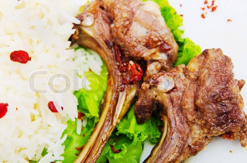 Lamb ribs with rice served in the plate | Stock image | Colourbox