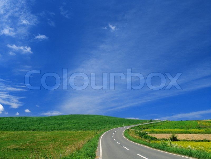 Landscape with road and cloudy blue sky | Stock Photo | Colourbox