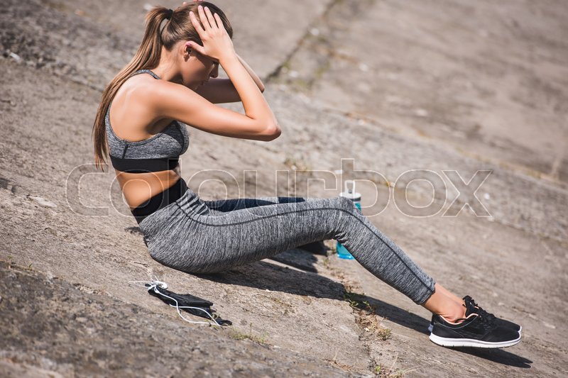 Side view of athletic woman doing abs ... | Stock image | Colourbox