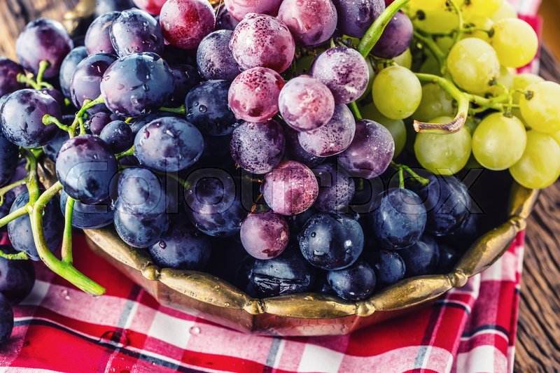Grape. Bunch of multicolored grapes in ... | Stock image | Colourbox