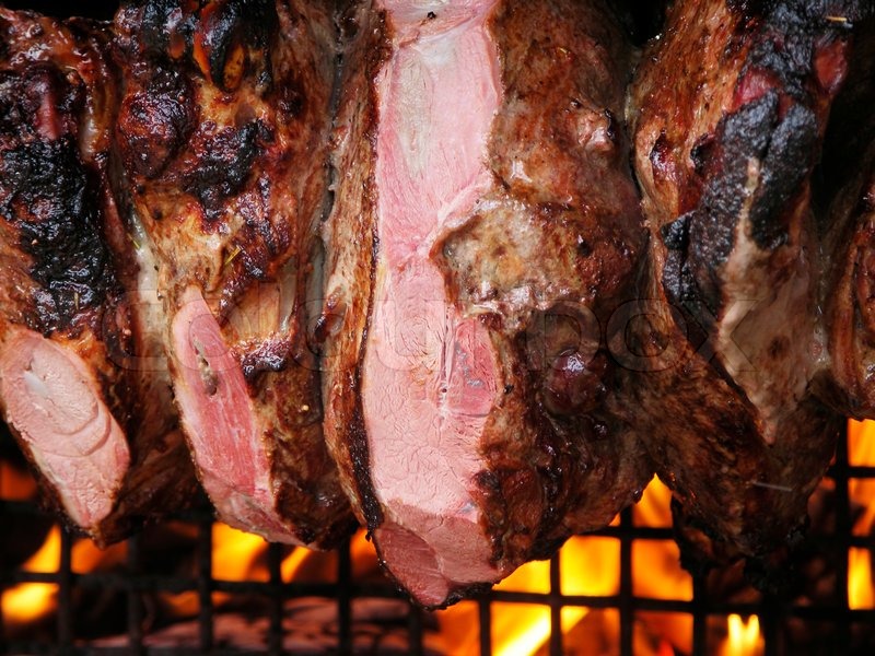 Roast meat by fire with flames, ... | Stock image | Colourbox