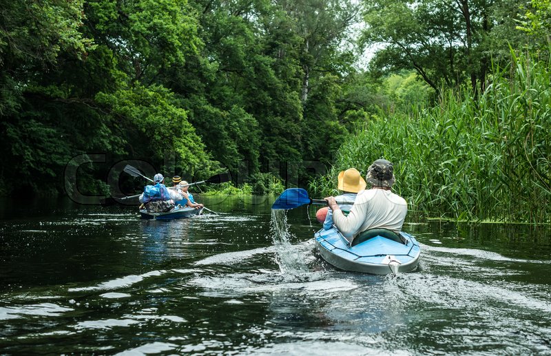 People canoeing on the river surrounded ... | Stock image | Colourbox