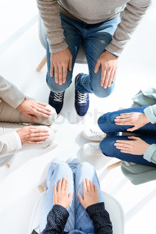 Top view of people sitting with hands ... | Stock image | Colourbox