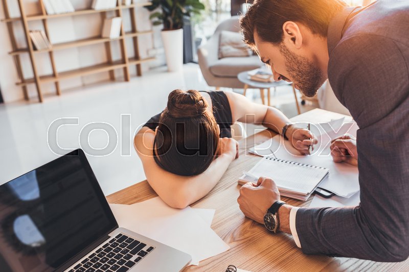 Young secretery crying on desk while ... | Stock image | Colourbox