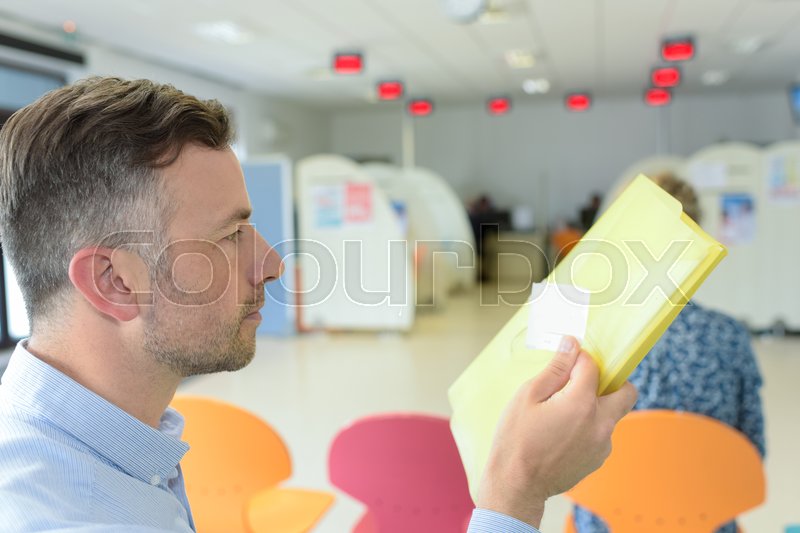 Male patient waiting in hospital lobby | Stock image | Colourbox