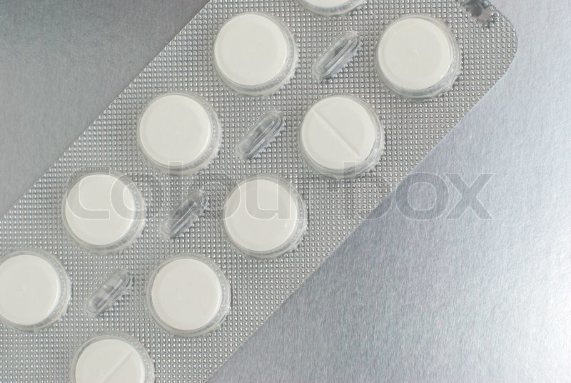 Macro of medical pills on a silver ... | Stock image | Colourbox