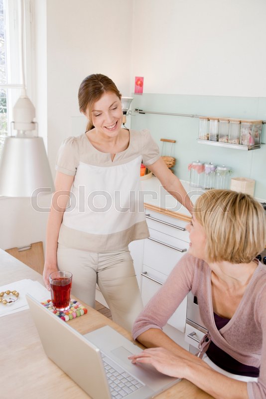 Women in kitchen talking | Stock image | Colourbox
