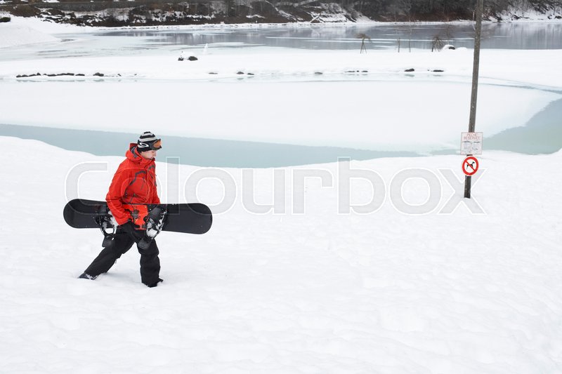 Guy in red jacket, walking in deep snow | Stock image | Colourbox
