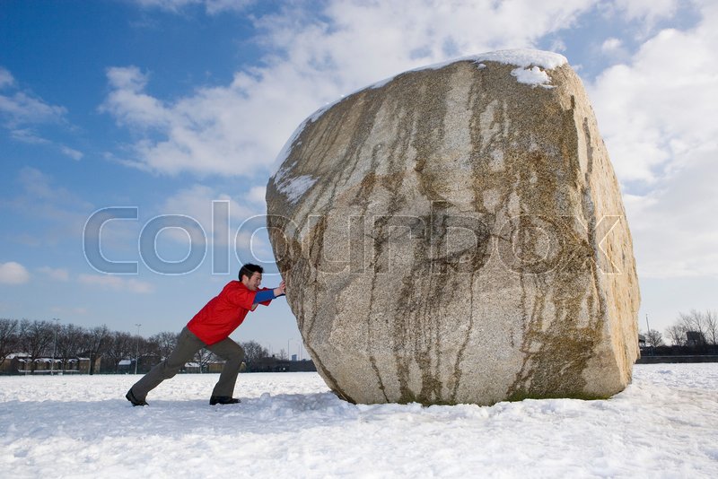 Man pushing boulder | Stock image | Colourbox