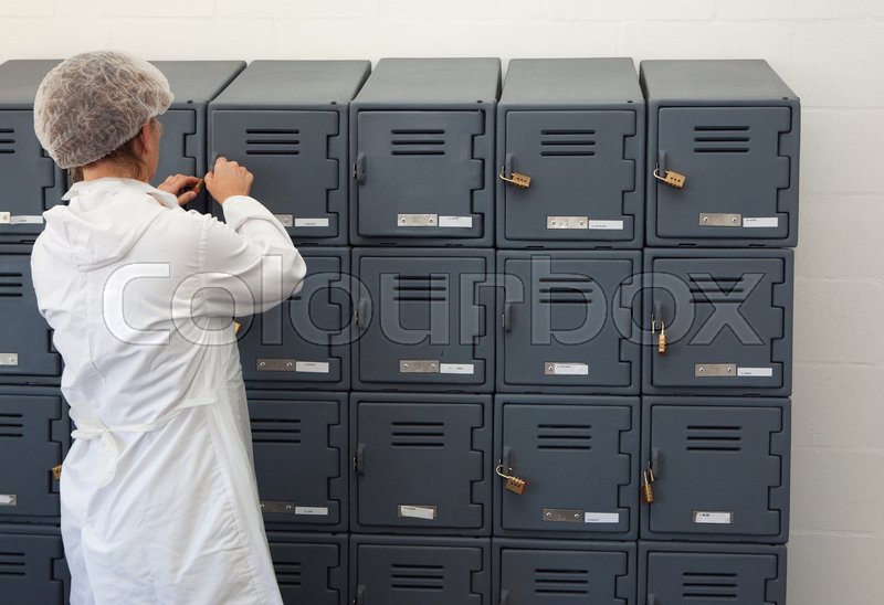 Factory worker opening locker | Stock image | Colourbox