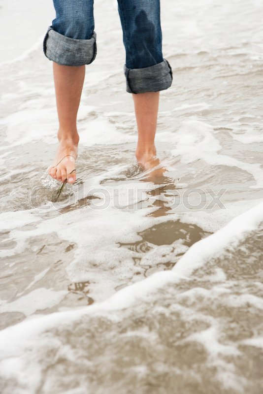 Girl wading in ocean | Stock image | Colourbox