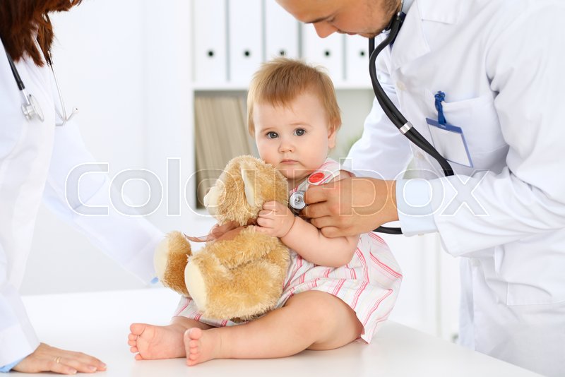 Two pediatricians are taking care of ... | Stock image | Colourbox