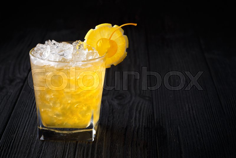 Yellow alcohol cocktail with cherry and ... | Stock image | Colourbox