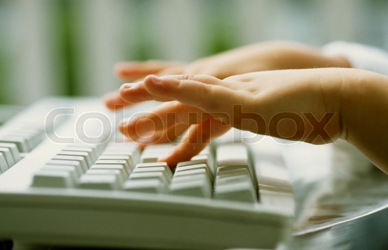 Child typing close up a picture of ... | Stock image | Colourbox