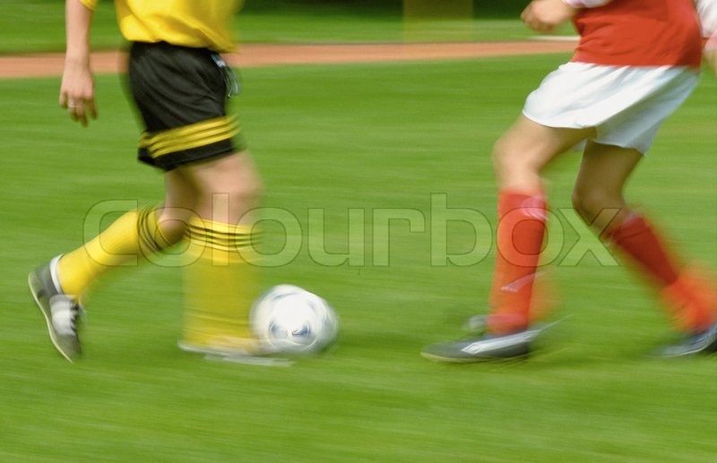 Soccer players running after the ball ... | Stock image | Colourbox