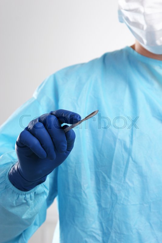 Man surgeon holds a scalpel in an ... | Stock image | Colourbox