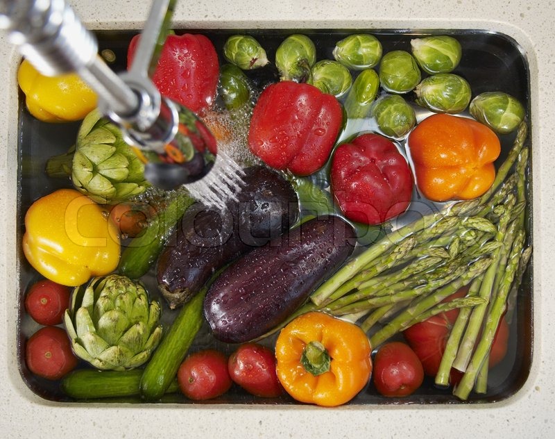 Washing vegetables in the Kitchen Sink | Stock Photo | Colourbox
