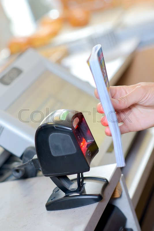 Librarian scanning barcode | Stock image | Colourbox