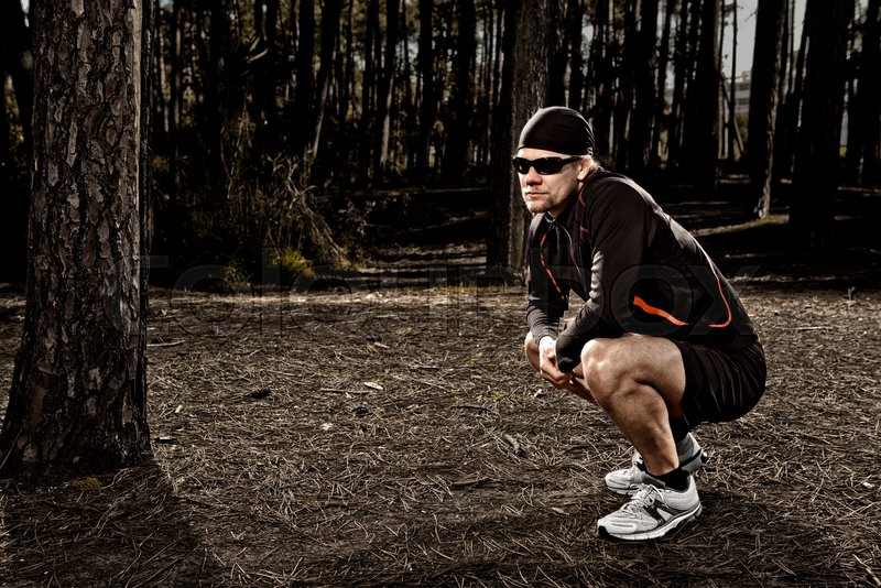Athletic man resting after running in ... | Stock image | Colourbox
