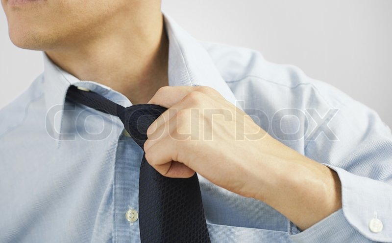 Man taking off neck tie | Stock image | Colourbox