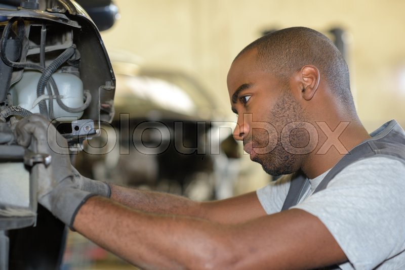 Diesel mechanic fixing a vehicle | Stock image | Colourbox