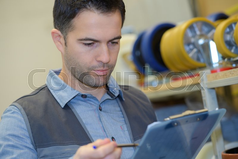 Engineer working in a warehouse | Stock image | Colourbox