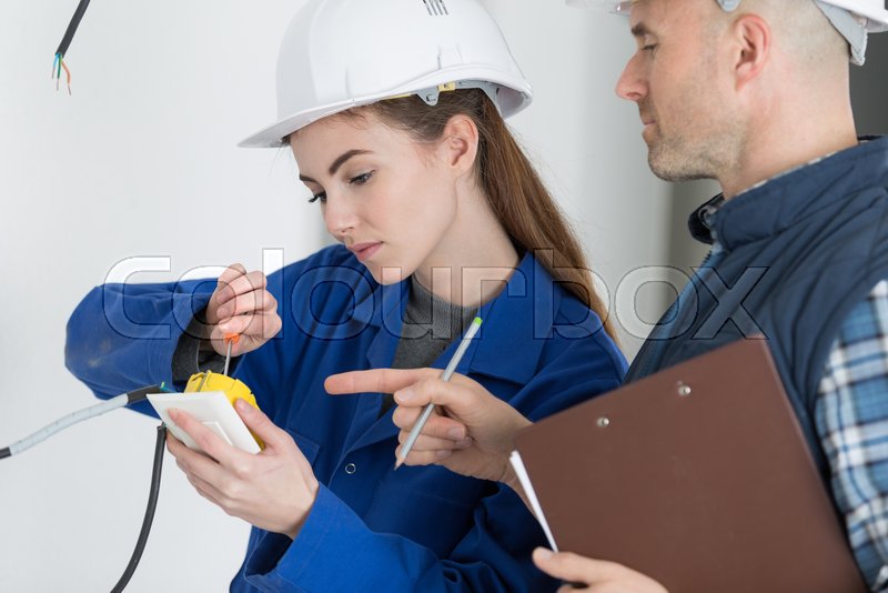 Electrician and his female apprentice ... | Stock image | Colourbox