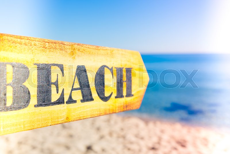 Wooden sign pointing to a beach on a ... | Stock image | Colourbox