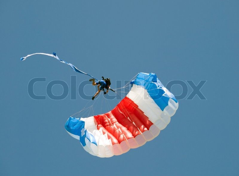 Skydiver hanging on parachute in air | Stock image | Colourbox