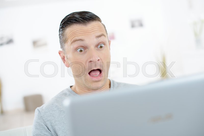 Shocked businessman working on computer ... | Stock image | Colourbox