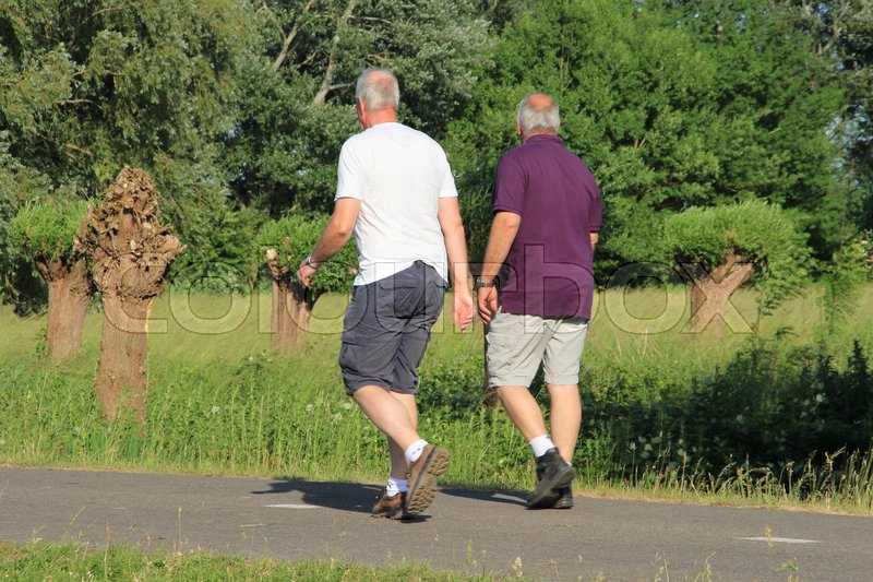 Two men are walking in the park of the ... | Stock image | Colourbox